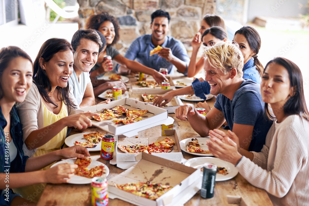 Its time for a pizza party. Cropped shot of a group of friends enjoying ...