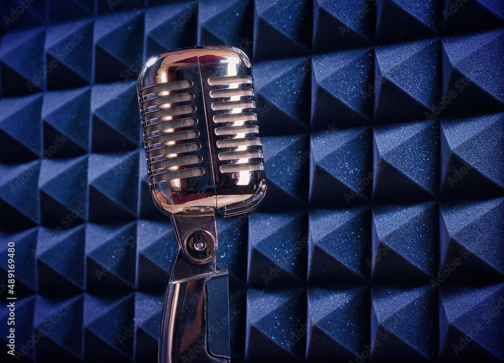 Old style mic, in an isolated recording studio booth. Retro ...