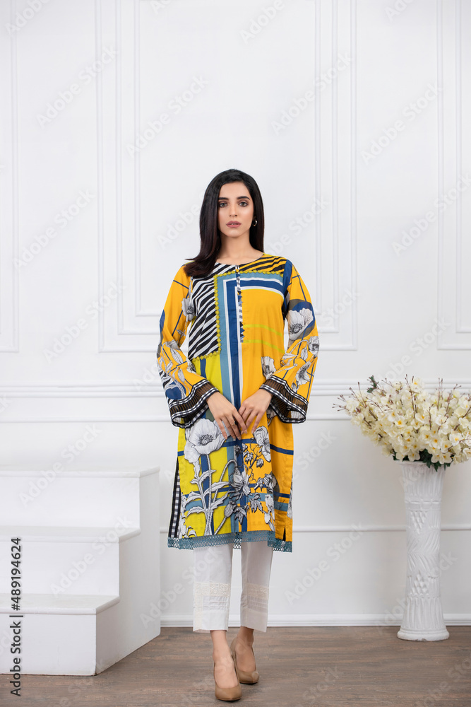 A Pakistani shalwar kameez suit with dupatta. Pakistani model is shown ...