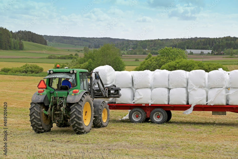 Farmer Stacks up Silage with Front Loader John Deere 6330 Tractor onto ...