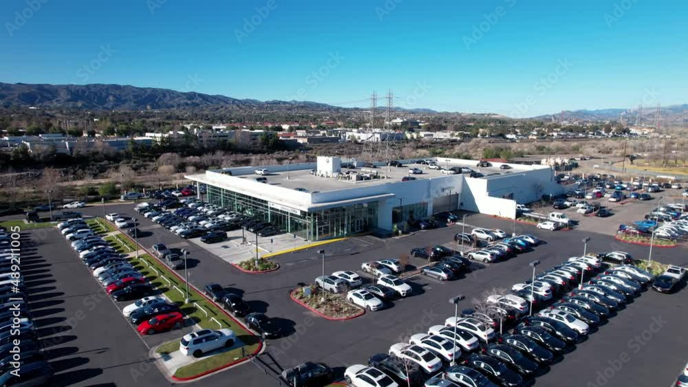 A car dealership with a full inventory in the parking lot in an ...