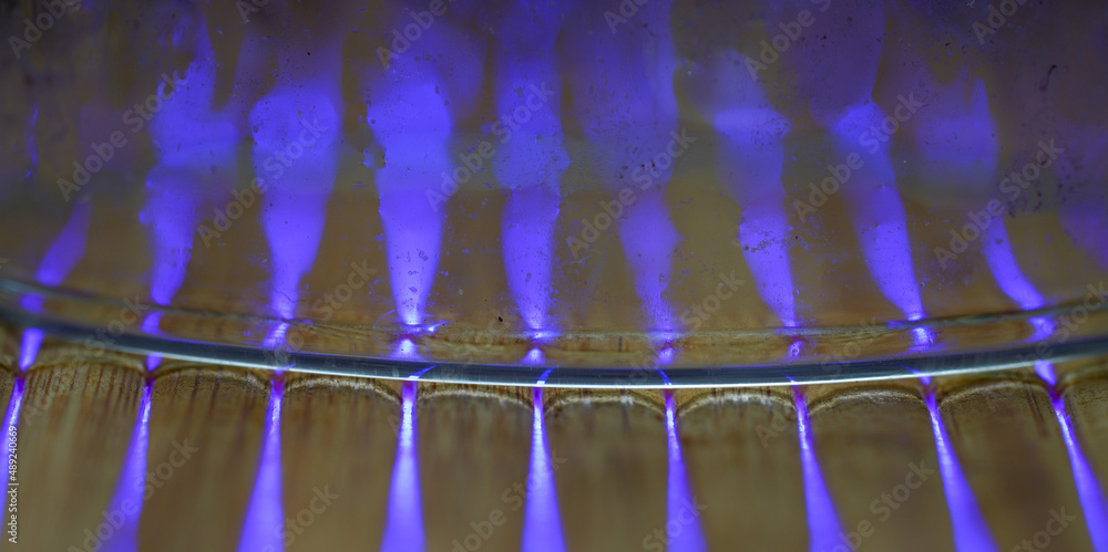 Glass lit from below with colored light creates consuming patterns to ...