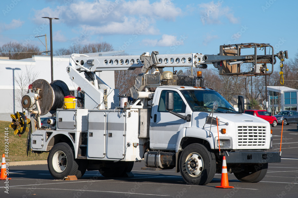 Front and side view of parked communication utility trucks in ...