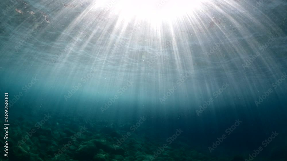 sun ray and sun beam scenery underwater waves on surface of water slow ...