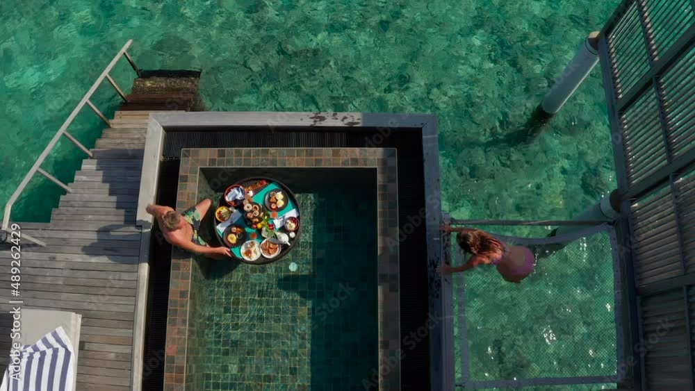 Drone top down view: Young couple on honeymoon enjoying fresh breakfast ...