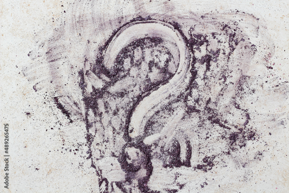 Question mark drawn by purple paint powder on a neutral background ...