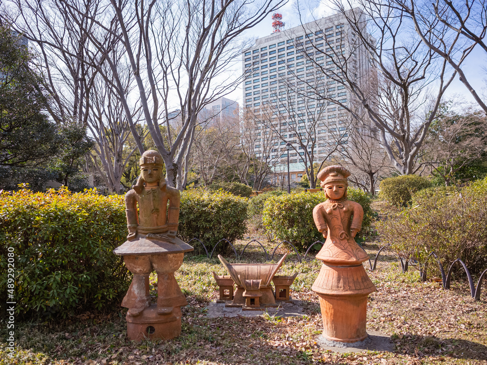 japanese haniwa statue standing in the hibiya park and city building ...