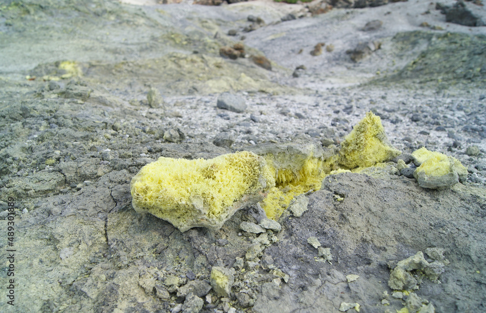 chunks of crystalline sulfur in a volcanic landscape on the slope of ...
