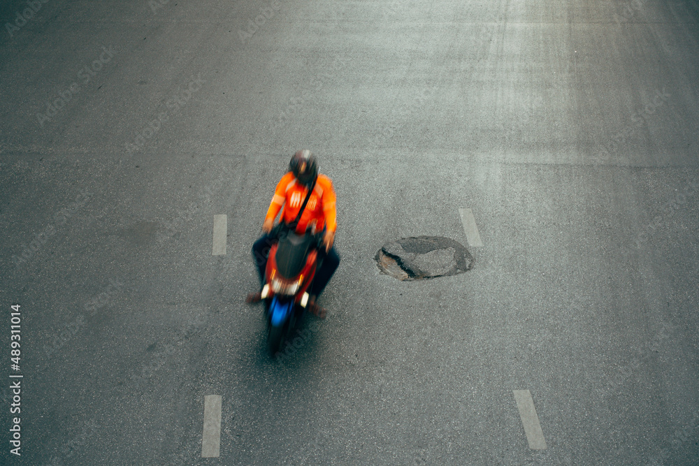 Blurred delivery driver on a scooter Stock Photo | Adobe Stock