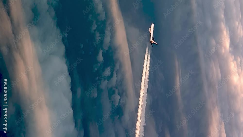 Cropped portrait view from cockpit of flying airplane above clouds ...