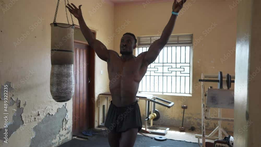 Black African bodybuilder posing in old school gym in Africa. Classic ...