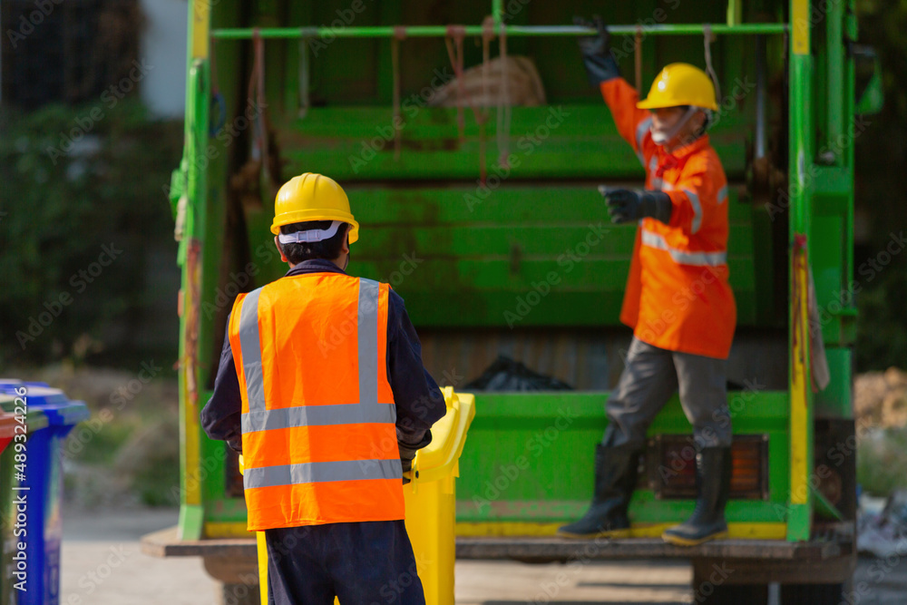 Garbage collector, teamwork garbage men working together on emptying ...