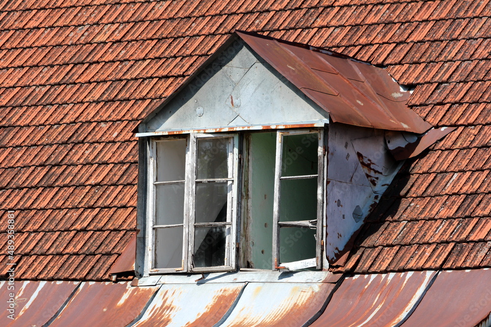 Large old damaged roof window with destroyed cracked wooden window ...