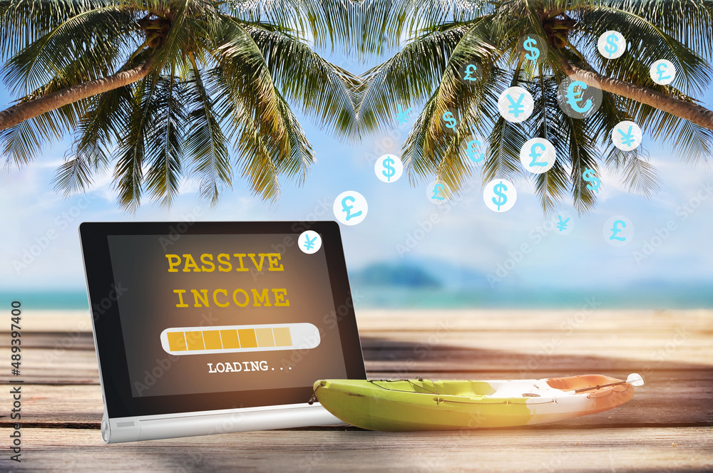 Passive income loading on computer digital tablet with currency on ...