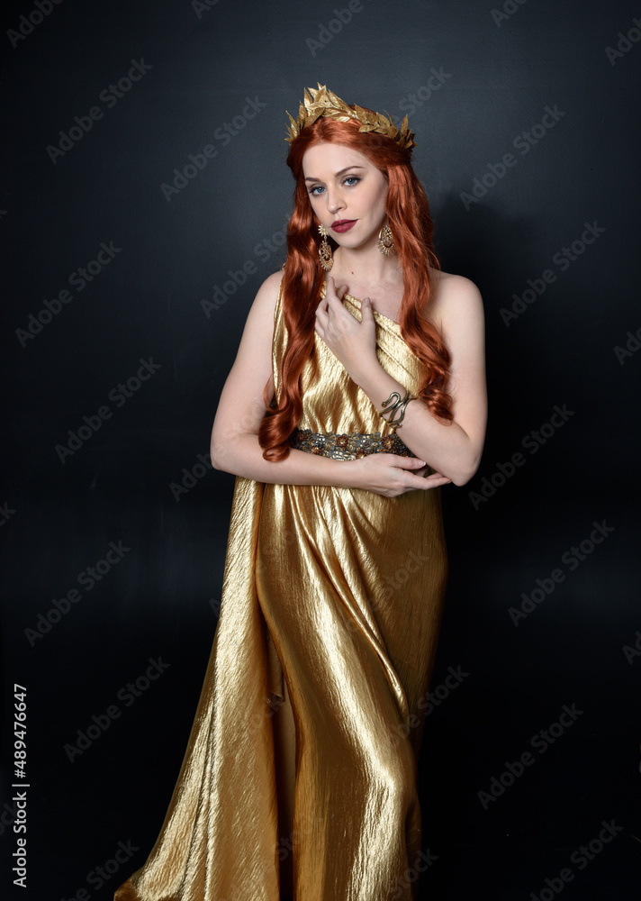 Full length portrait of pretty female model wearing grecian goddess ...