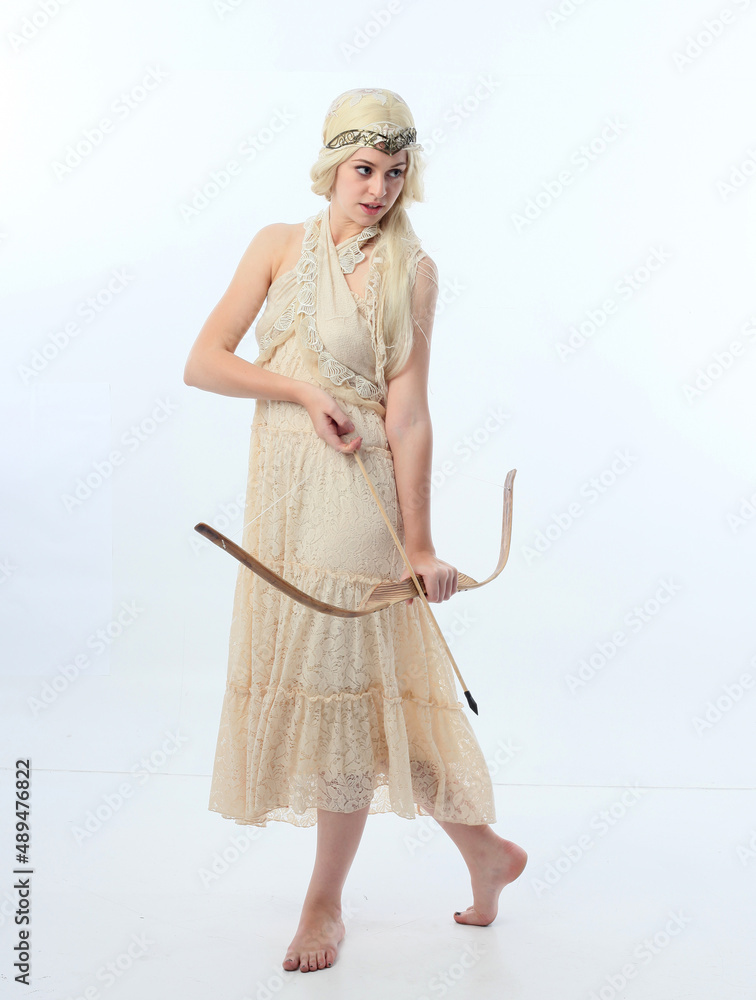 Full length portrait of pretty female model wearing grecian goddess ...