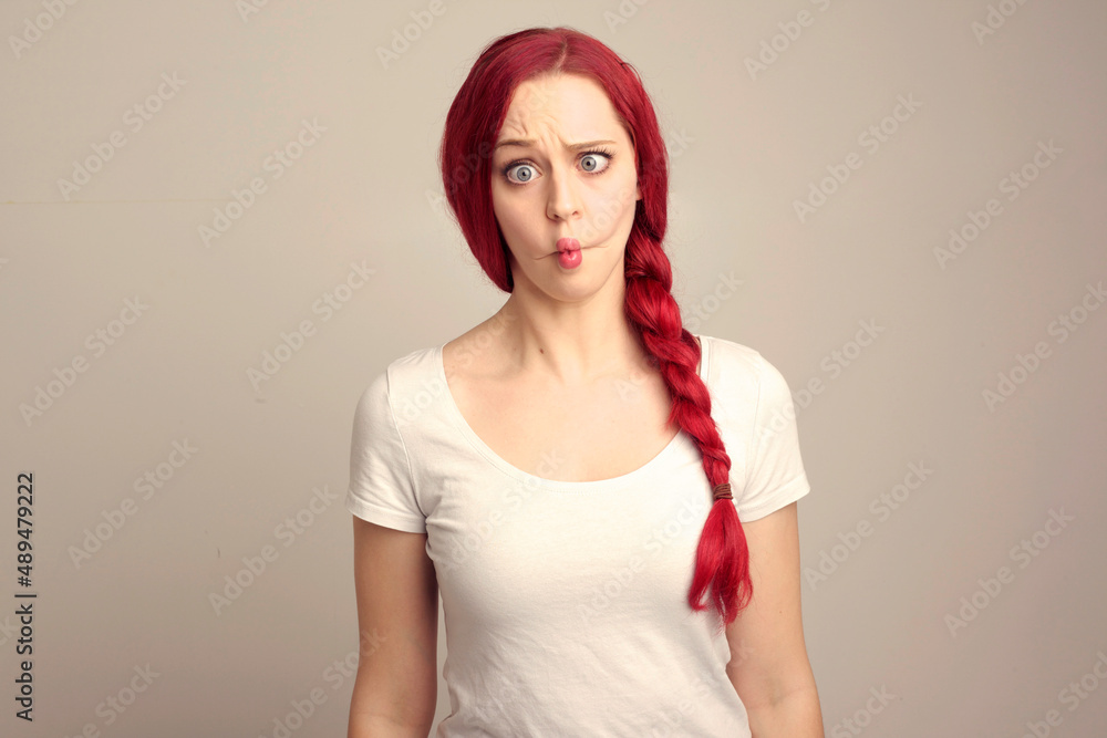 close up portrait of pretty female model with red hair in a braid ...