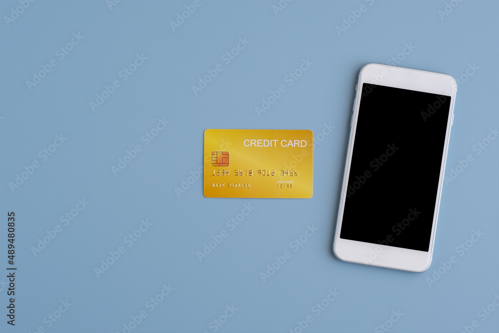 Hand touch blank screen mobile phone and credit card isolated on gray ...