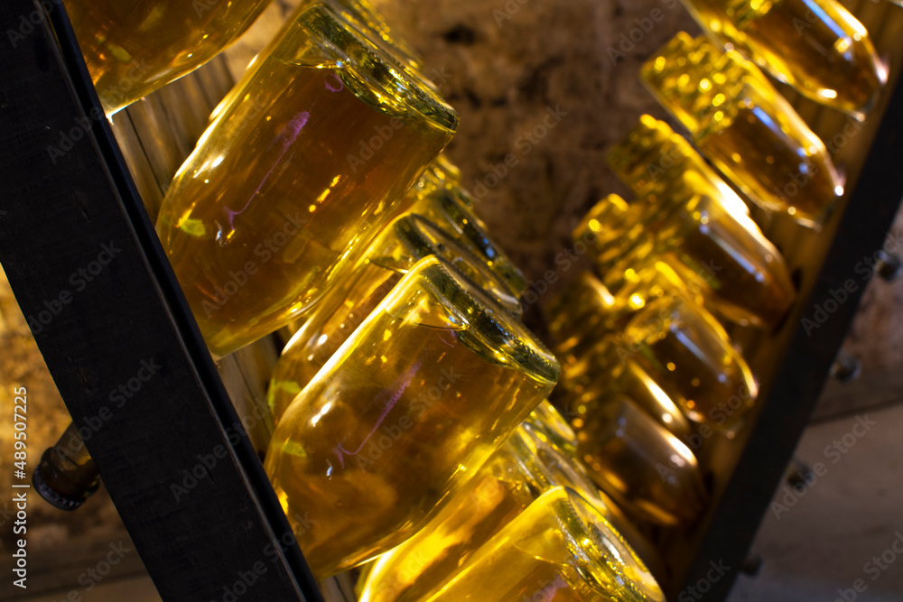 Sparkling wine production by traditional method in underground cellars ...