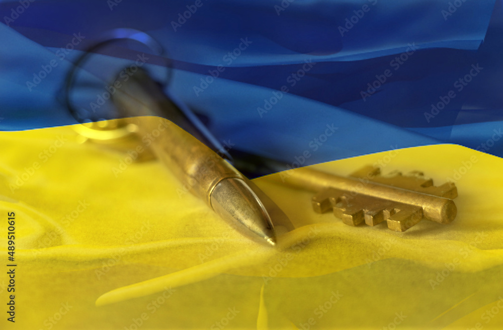 A military bullet from a machine gun and house keys against the ...