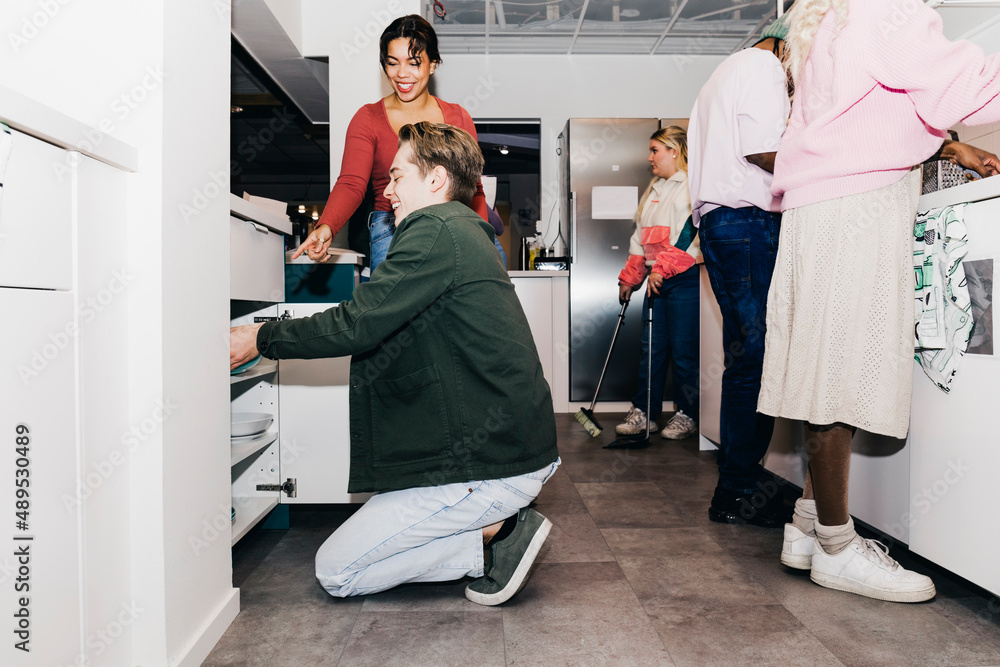 Multiracial male and female students doing chores in dorm Stock Photo ...