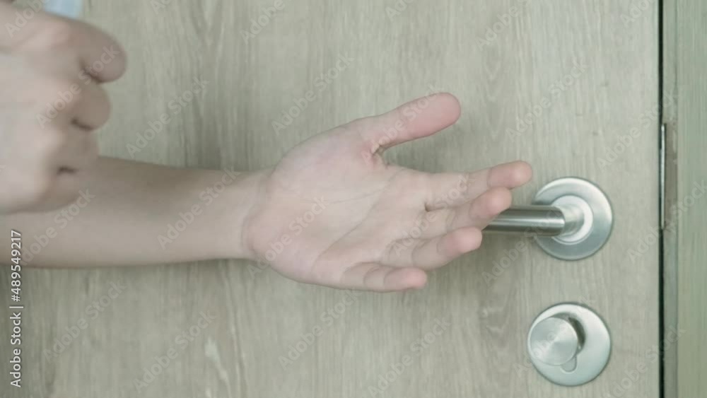 man's hand closing the door to the house After touching the doorknob ...