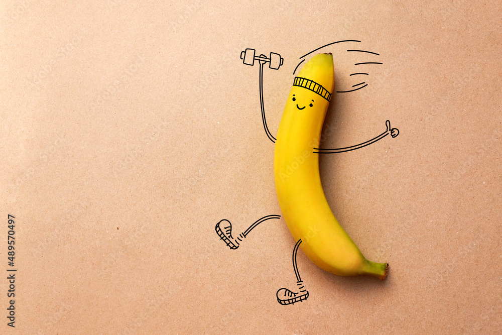 Banana athlete with dumbbells. A symbol of a healthy snack for ...