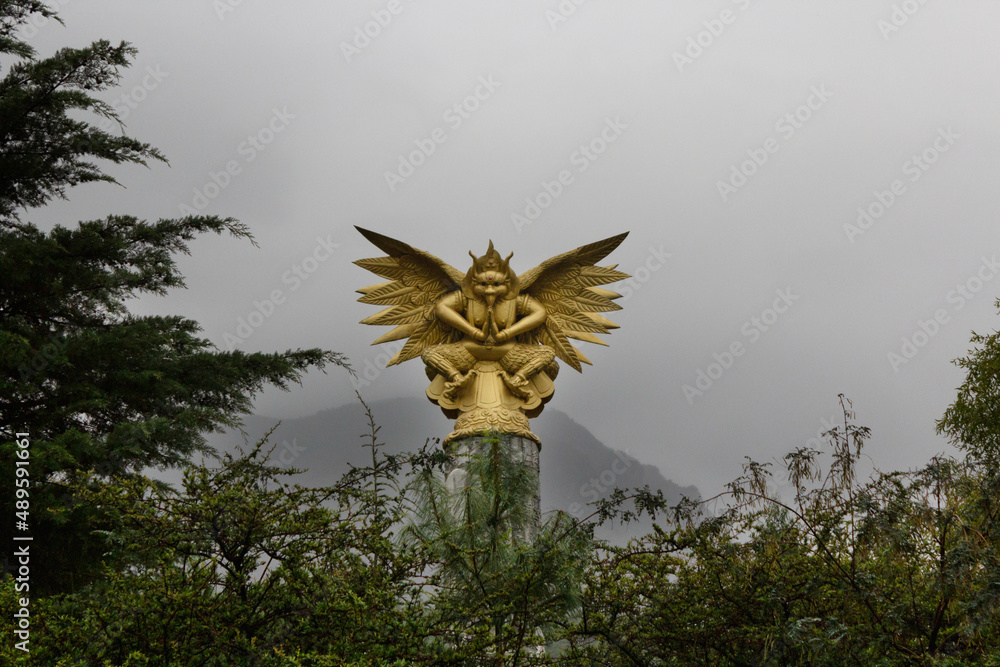 a golden statue of a jade water dragon is throning on a pedestal in the ...