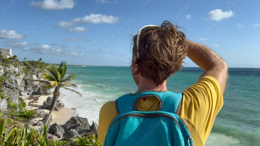 Tourist male photographing the Tulum ruins in Mexico. People ...