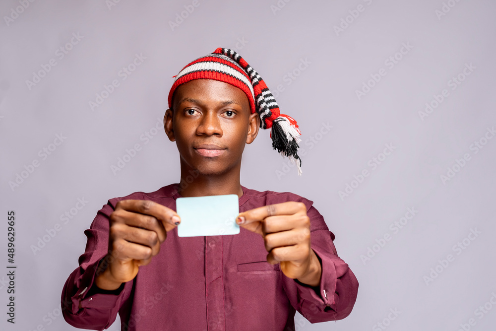 african man wearing african attire dress holding id card mock up with ...