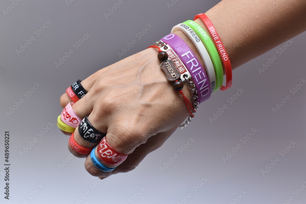 Hand wrist with friendship bands and friendship rings on the occasion ...