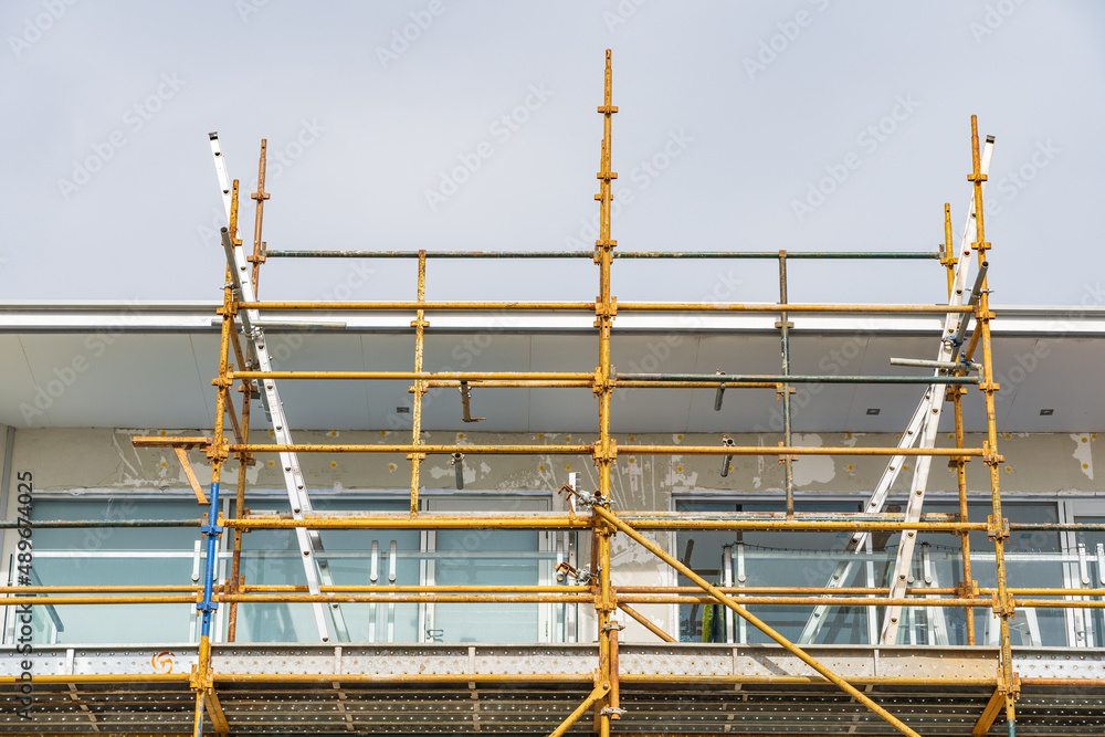 Construction scaffolding up the side of a high rise building Stock ...