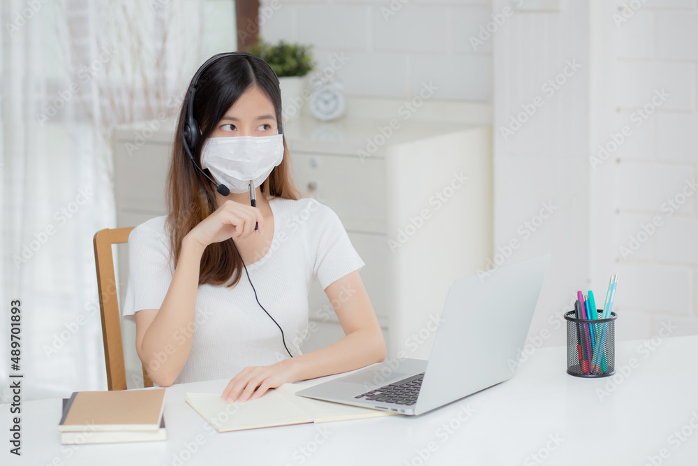 Young asian woman wearing headphone study online with e-learning on ...