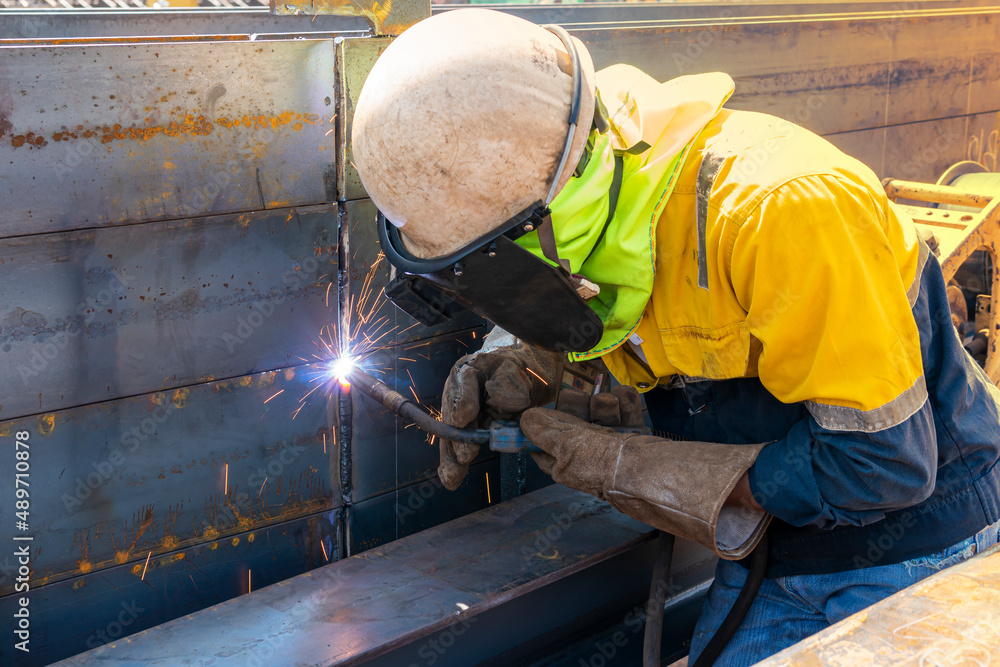 Welder is welding add joint h-beam for steel structure work with ...