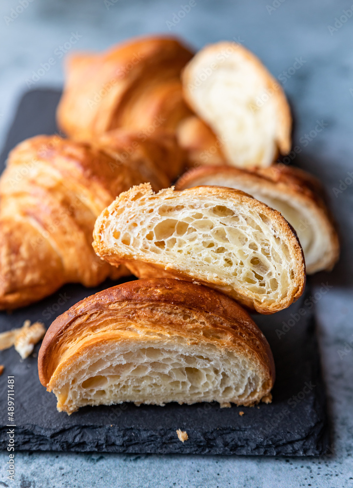 Cut in half croissant with inside texture and thin crisp layers on ...