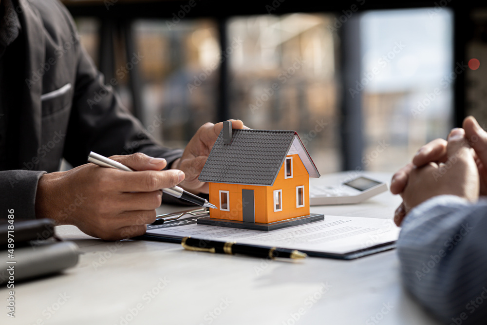 Rental company employee is discussing the details before the customer ...