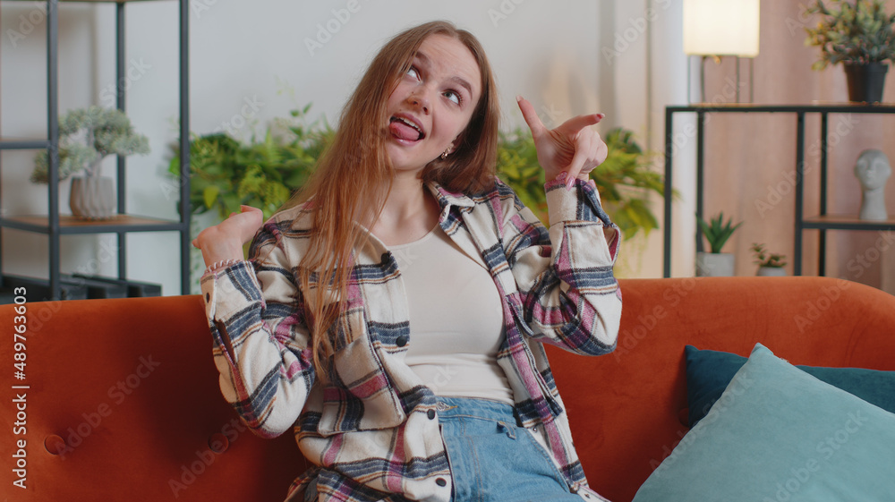 Funny amusing young funny woman in shirt looking awkward making playful ...