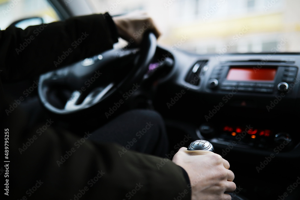 Hand on the car gear knob. The driver switches the speed in the car ...