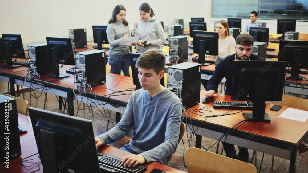 Group of people of different ages learning to use computers in ...