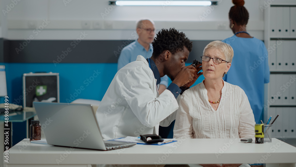 Healthcare specialist holding professional otoscope for ear examination ...