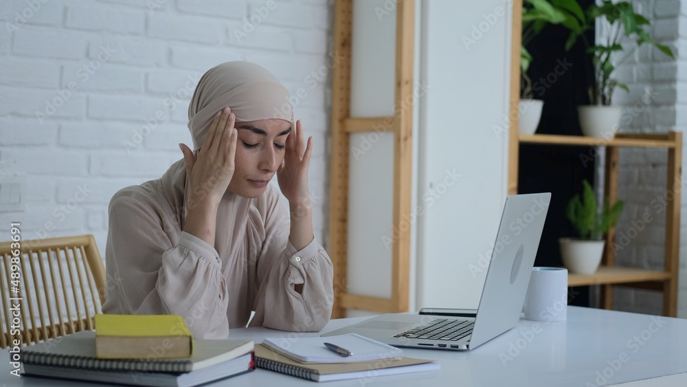 Overwhelmed Muslim student, Arab young woman in hijab-wearing, thinking ...