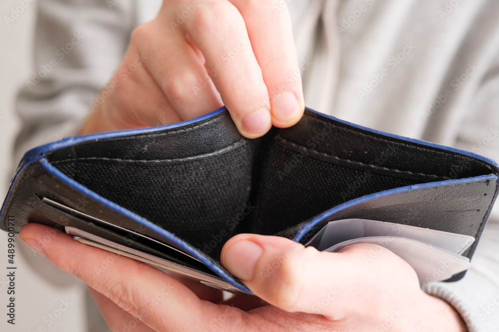 Man hand showing an open empty wallet close up. Poverty, cost control ...