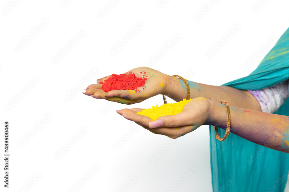 Young indian smart girl with gulal color powder in her hand for ...