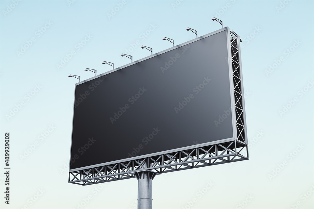 Blank black horizontal billboard on blue sky background at sunset ...