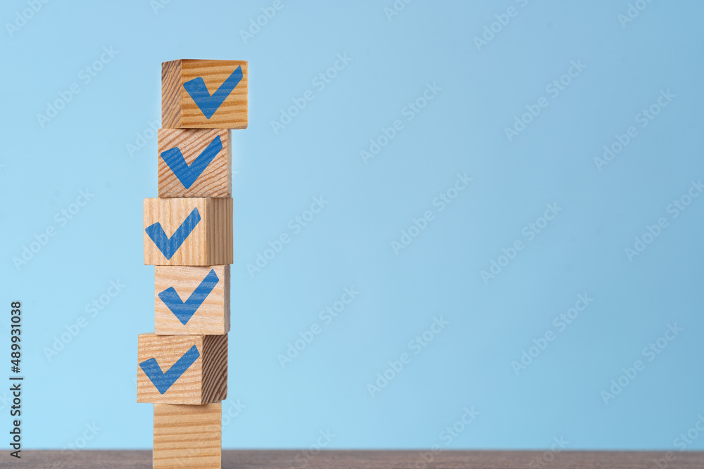 Stacked wooden cubes with blue checkmark. Concept of checklist, goal ...
