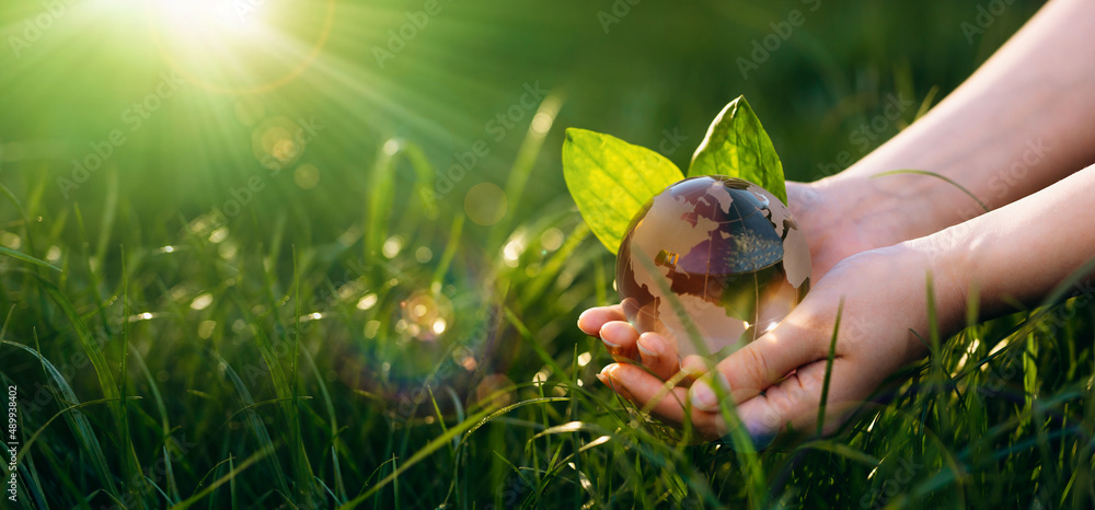 Hand holding crystal earth globe. Earth Day. Environment day, save ...