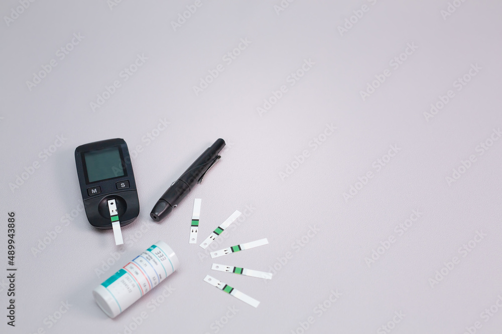 Diabetes equipment, glucose level blood test on blue background with ...