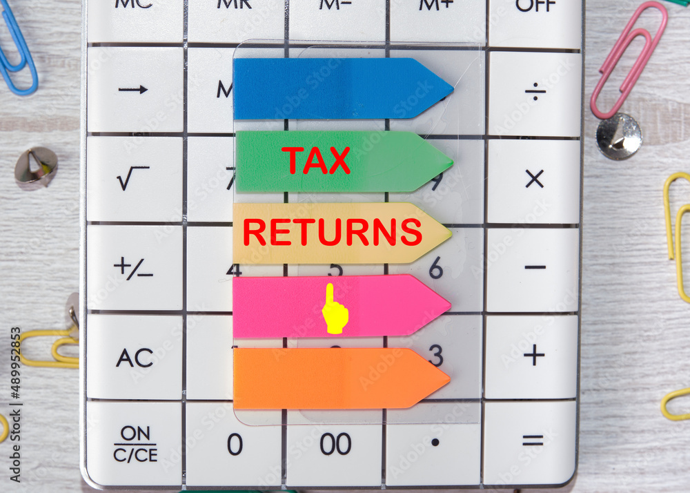 tax returns text is written on the stickers that are on the calculator ...
