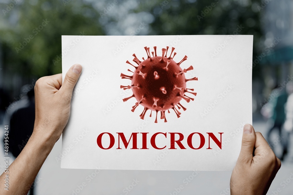 Omicron the new variant of the Covid-19 virus, Hand holds banner ...