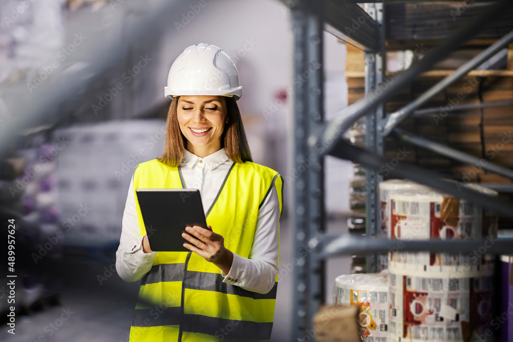 Female supervisor using tablet for data entry in warehouse. Stock Photo ...